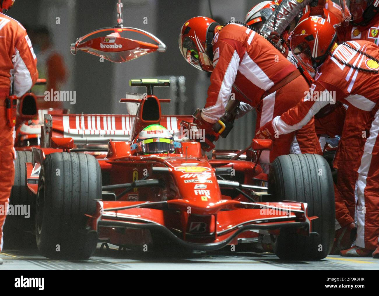 The Ferrari pit crew fails to get the fuel hose of the car of Ferrari ...