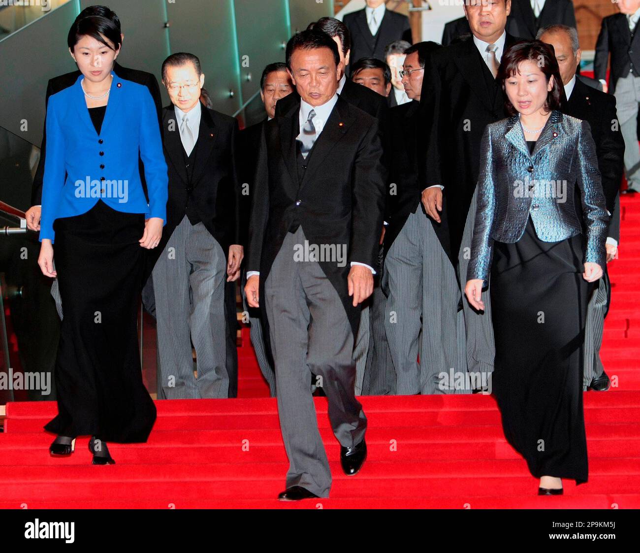 Japan's new Prime Minister Taro Aso, center, walks down the stairs with ...
