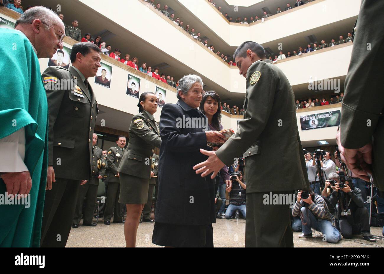 Police officer John Jairo Duran, right, handles personal belongings of ...