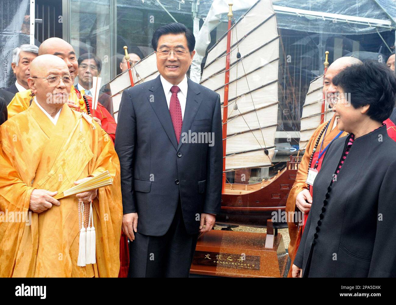 Chinese President Hu Jintao, center, and his wife Liu Yongqing, right ...