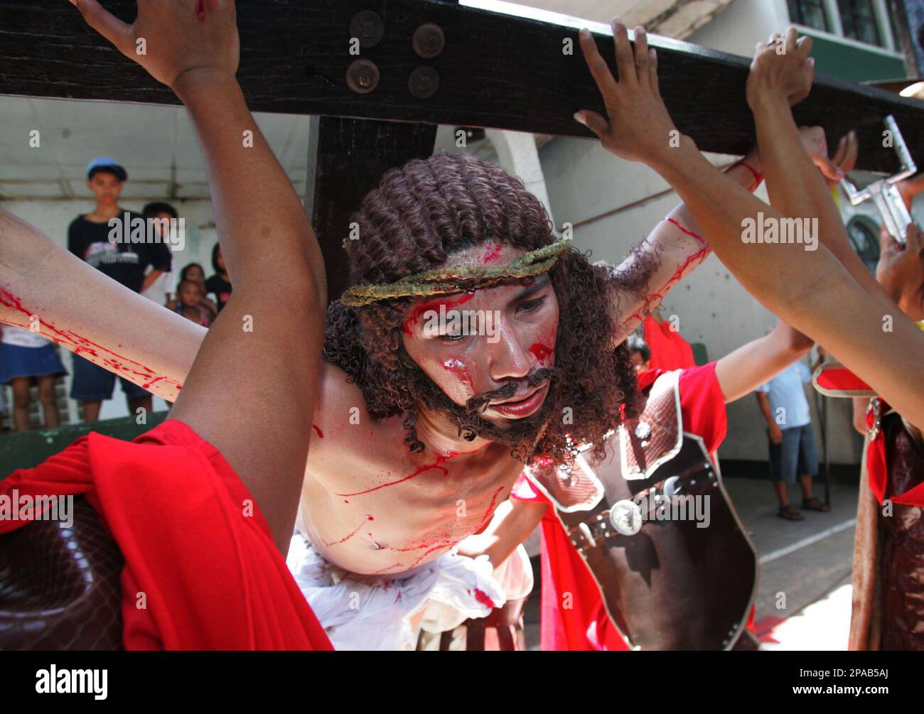 Gerardo Galvez Jr. portraying Jesus Christ, is mounted to a wooden ...