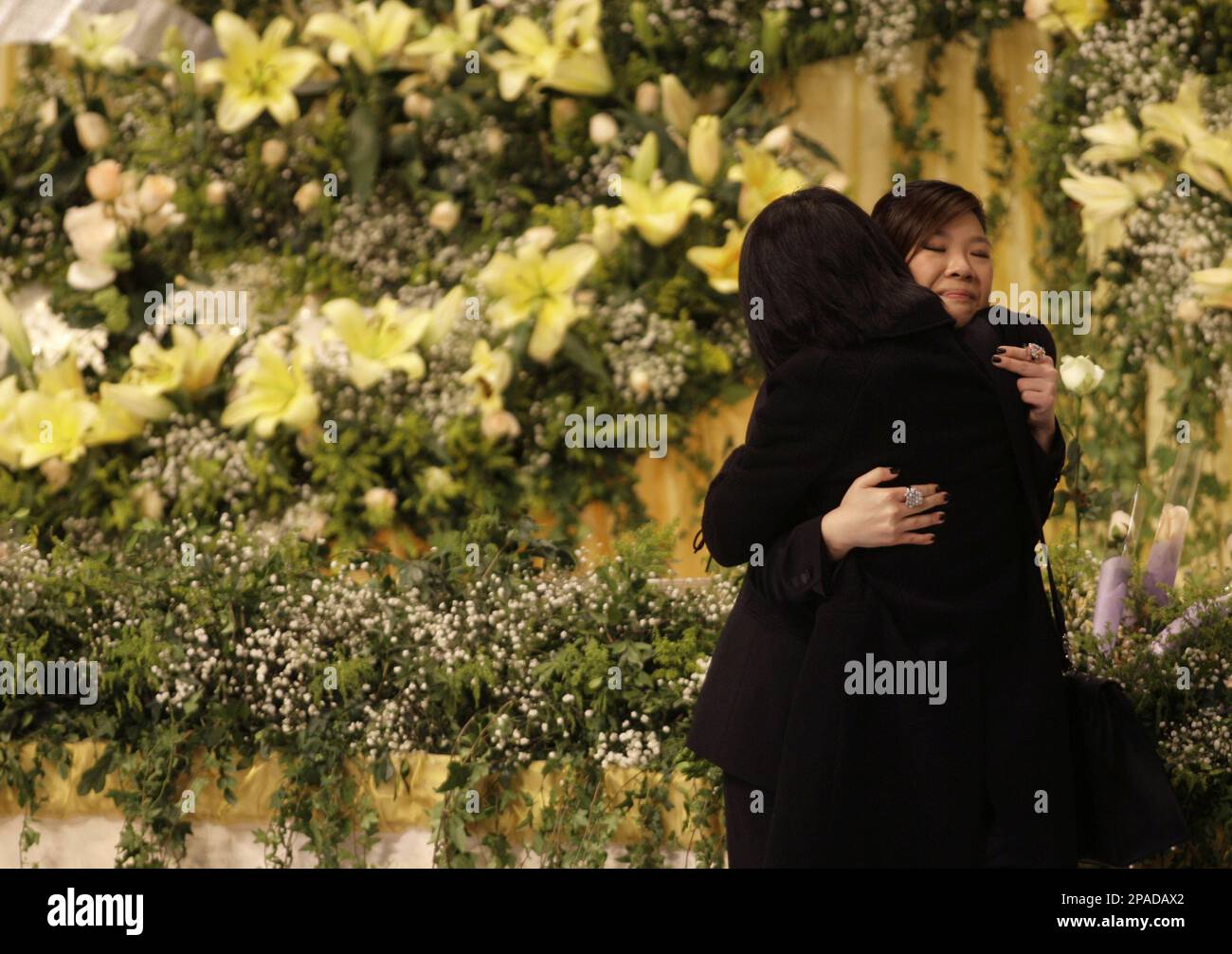 Lydia Sum's daughter Joyce Cheng hugs a friend during the public ...