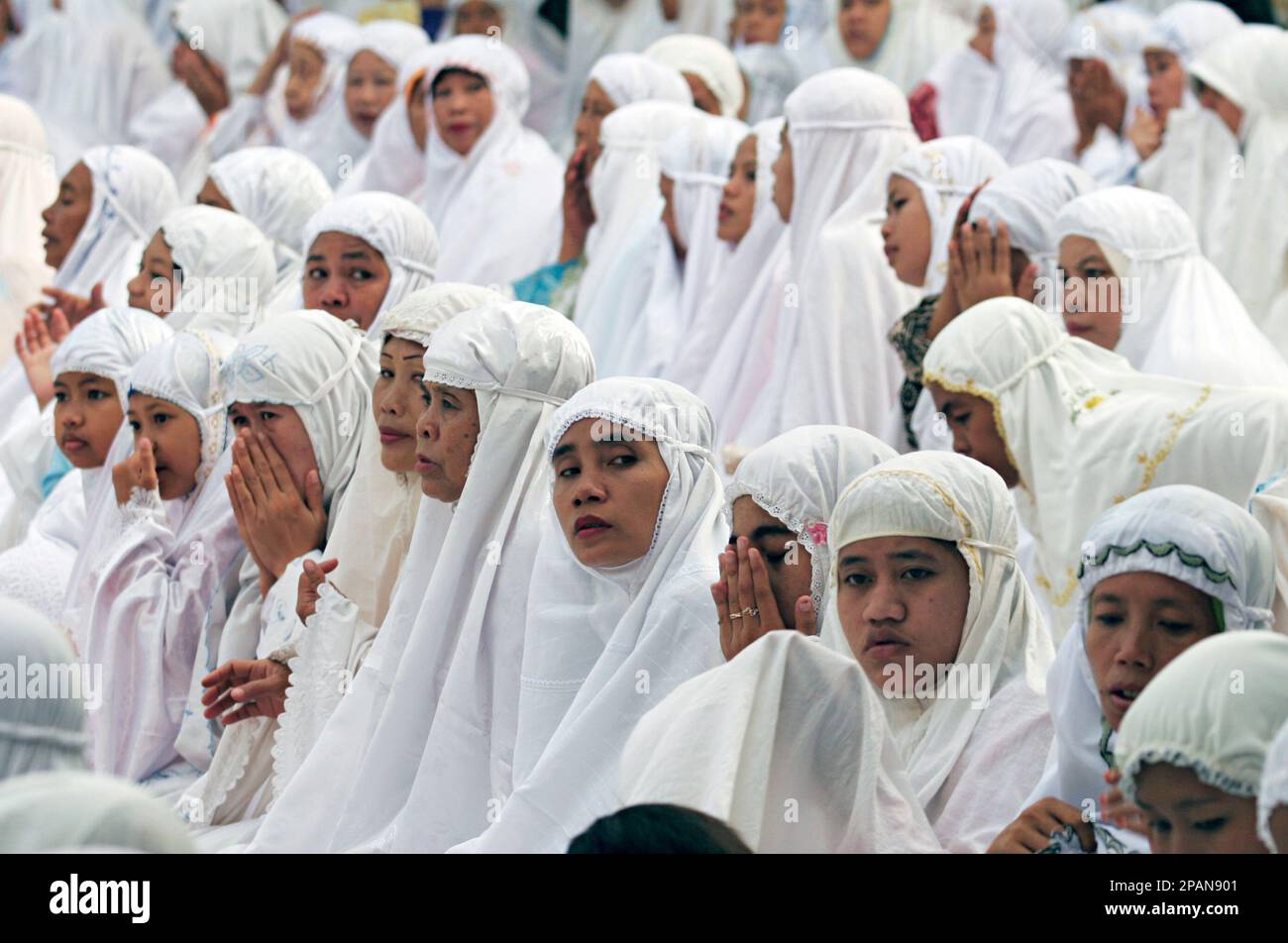 Indonesian Muslims take part in Eid al-Adha prayers at a mosque near a ...