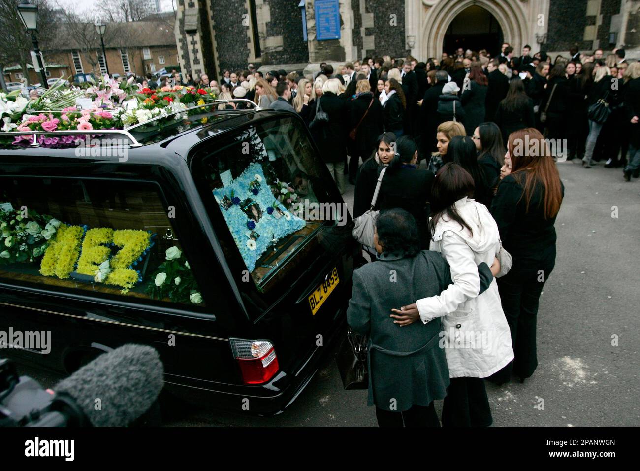 Mourners look into the hearse carrying the coffin of Meredith Kercher ...