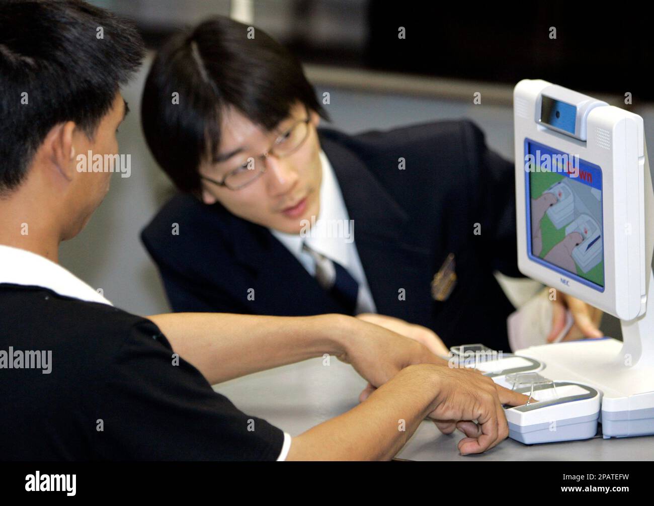 An immigration staff, background, at Narita international airport ...