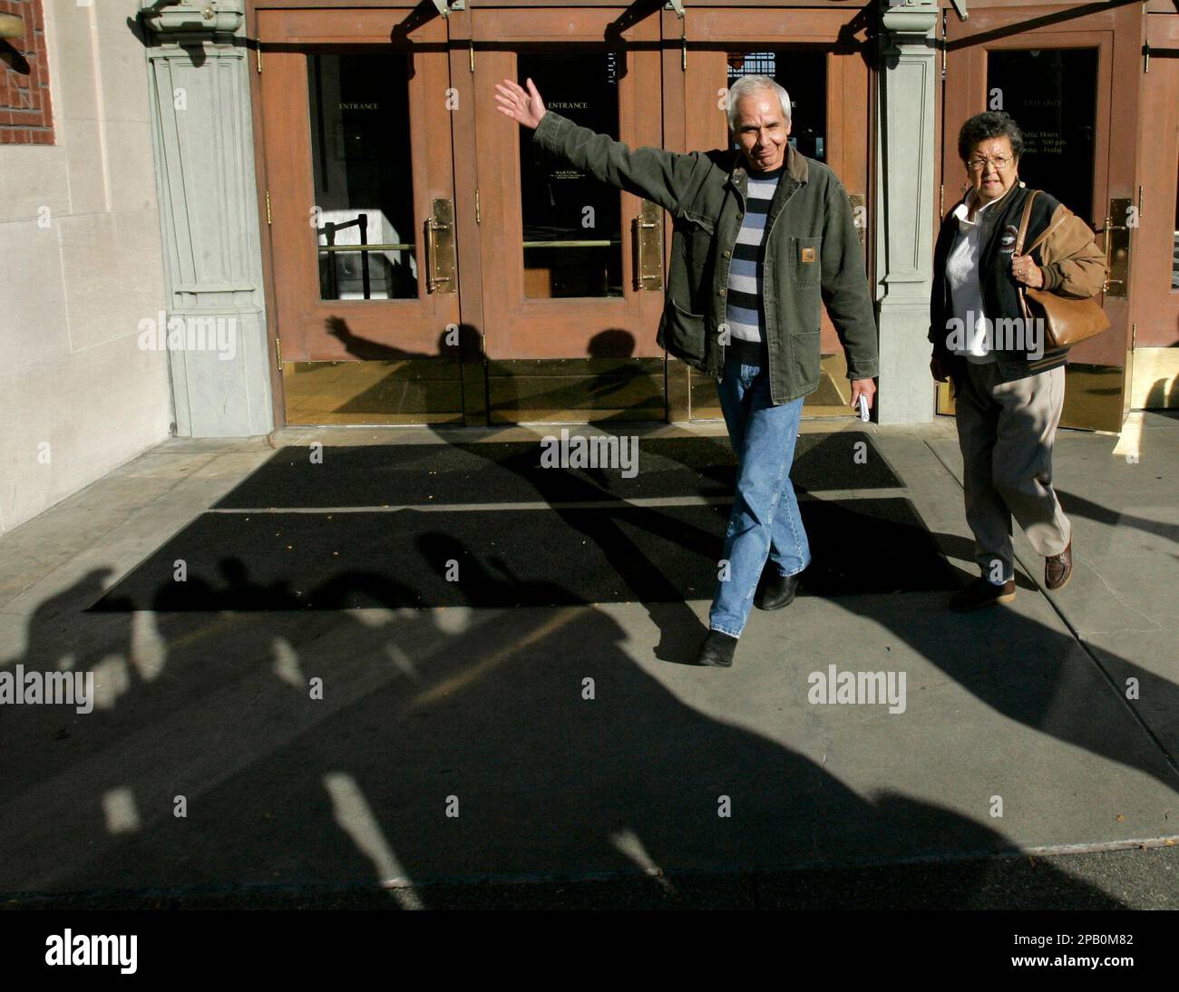 Wayne Johnson, left, makes a gesture of "no comment," as he leaves the ...