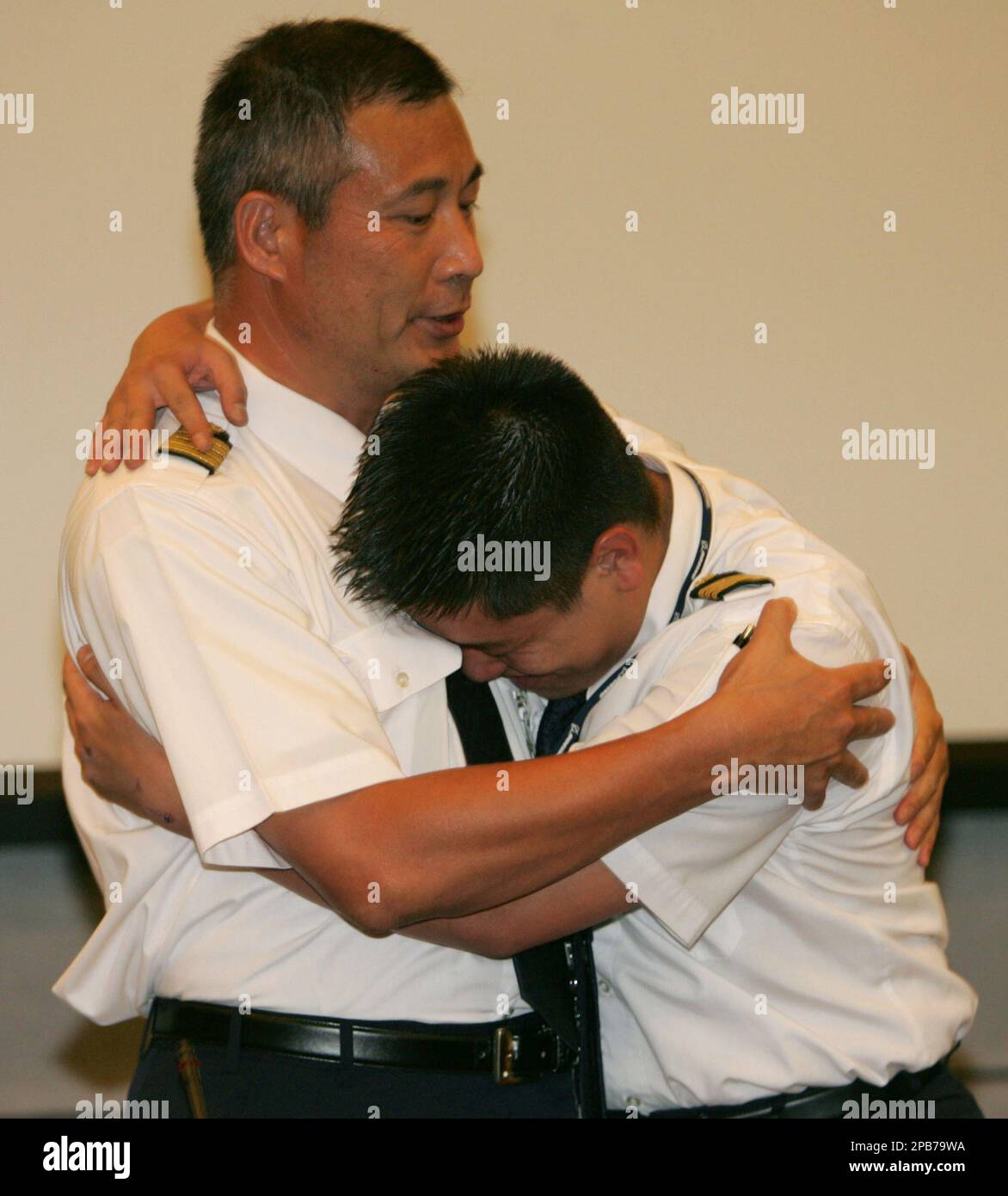Yu Chien-kuo, left, captain of the China Airlines' Boeing 737-800 that caught fire after landing ...