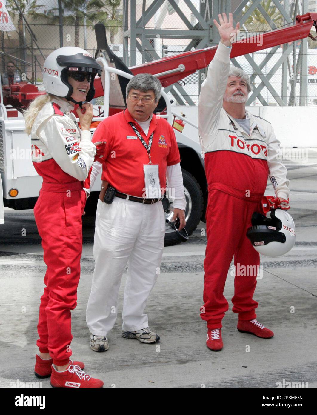 Movie magnate George Lucas waves to cheering fans before getting into ...