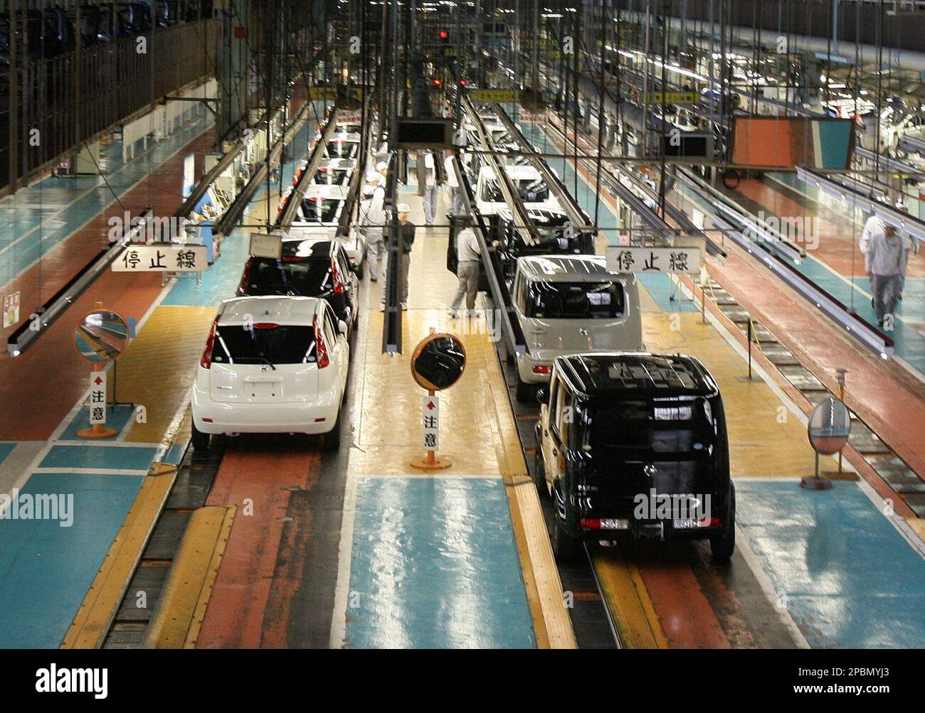 Vehicles line up on the assembly line at Nissan Motor's plant in ...