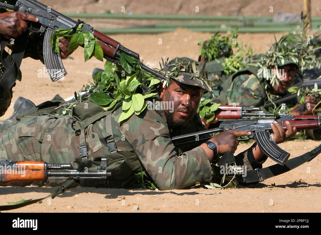 Palestinian miltants from Hamas wear camouflage as they display their ...