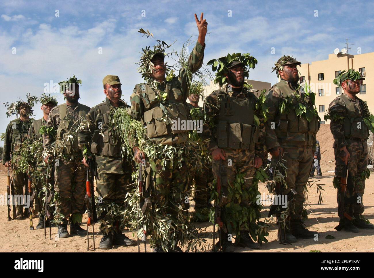 Palestinian miltants from Hamas wear camouflage as they stand at ...