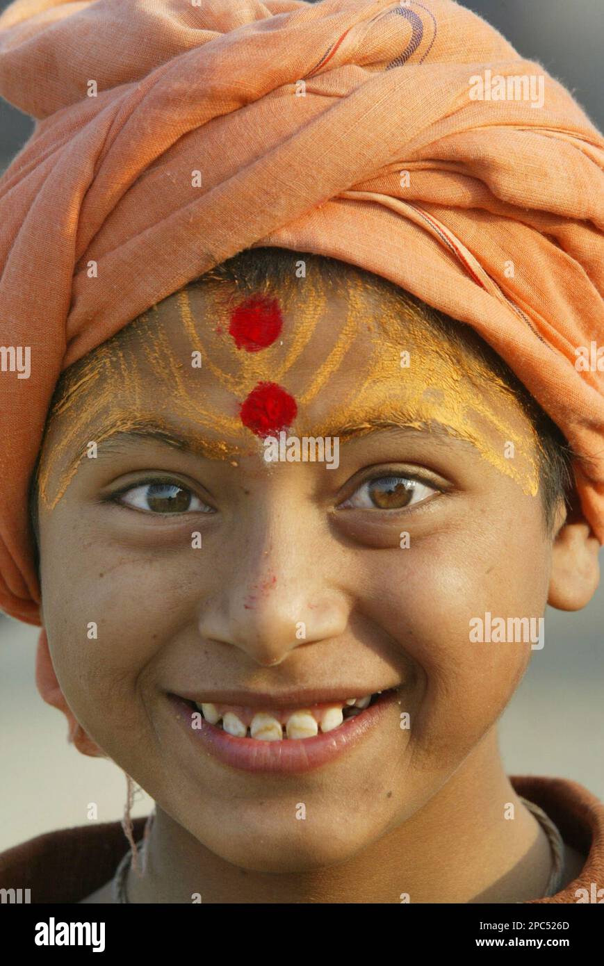 An Indian Sadhu boy, Hindu holy child smiles on the banks of River ...