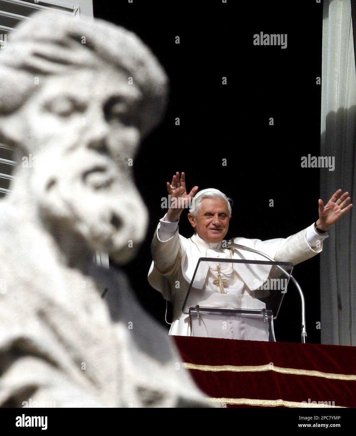 Pope Benedict XVI waves pilgrims and faithful from the window of his ...
