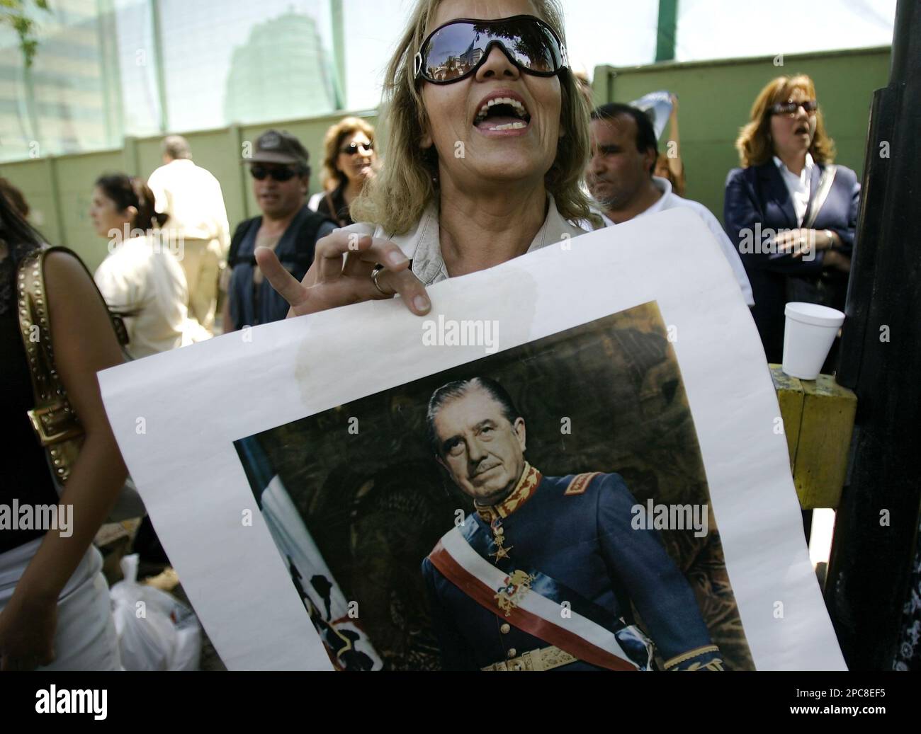 A supporter of former dictator Gen. Augusto Pinochet shouts slogans ...