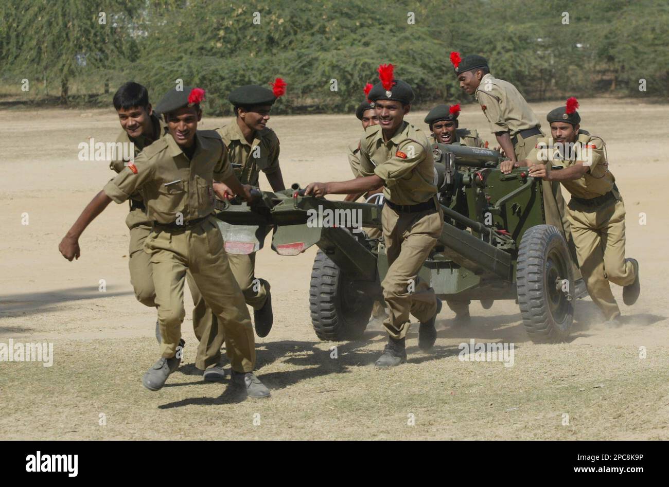 Cadets of the National Cadet Corps (NCC) push a powder gun during a ...