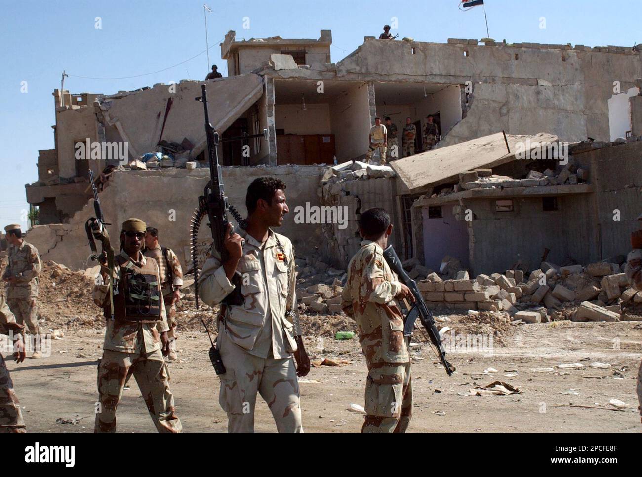Iraqi army soldiers stand guard at the spot where a suicide bomber ...