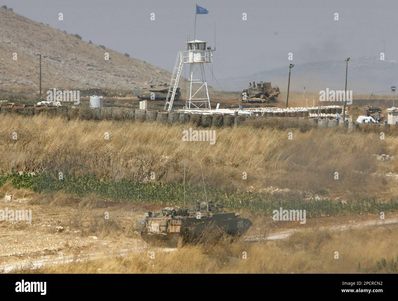 Israeli armored vehicles drive near a United Nations base inside ...