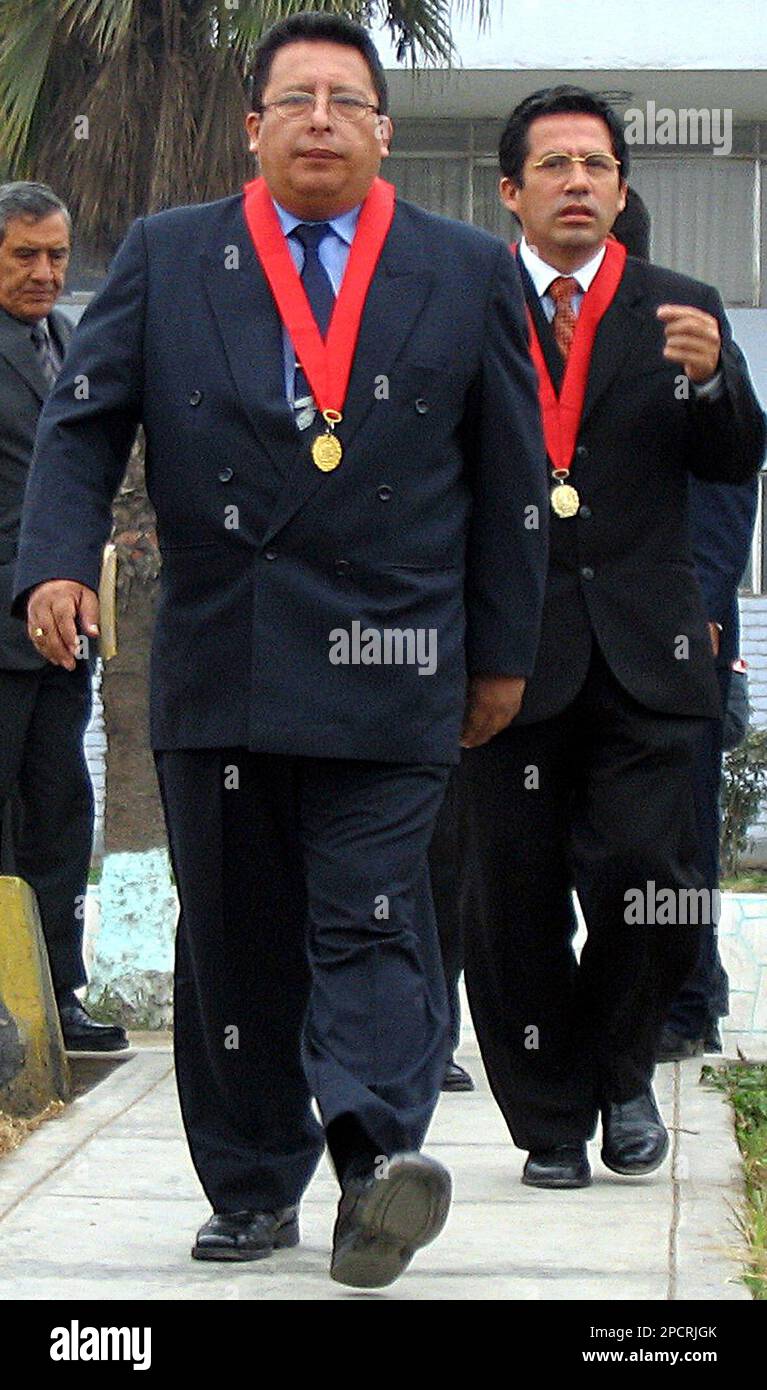 Peruvian judge Hernan Saturno Vergara, left, walks in this undated file ...