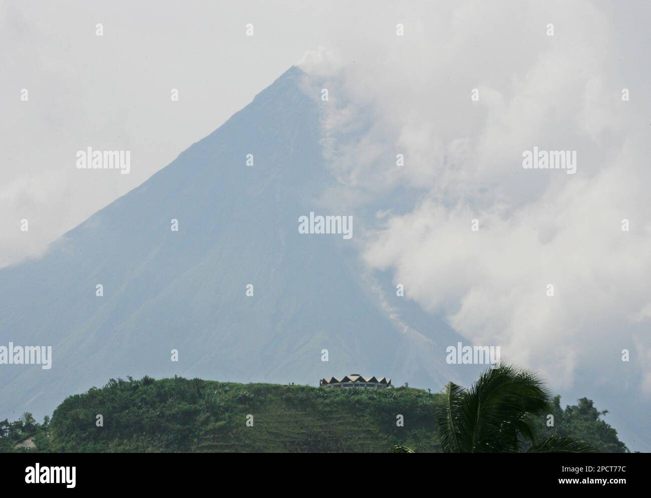 A cloud of grayish-brown lava fragments, center, flows down the gully ...