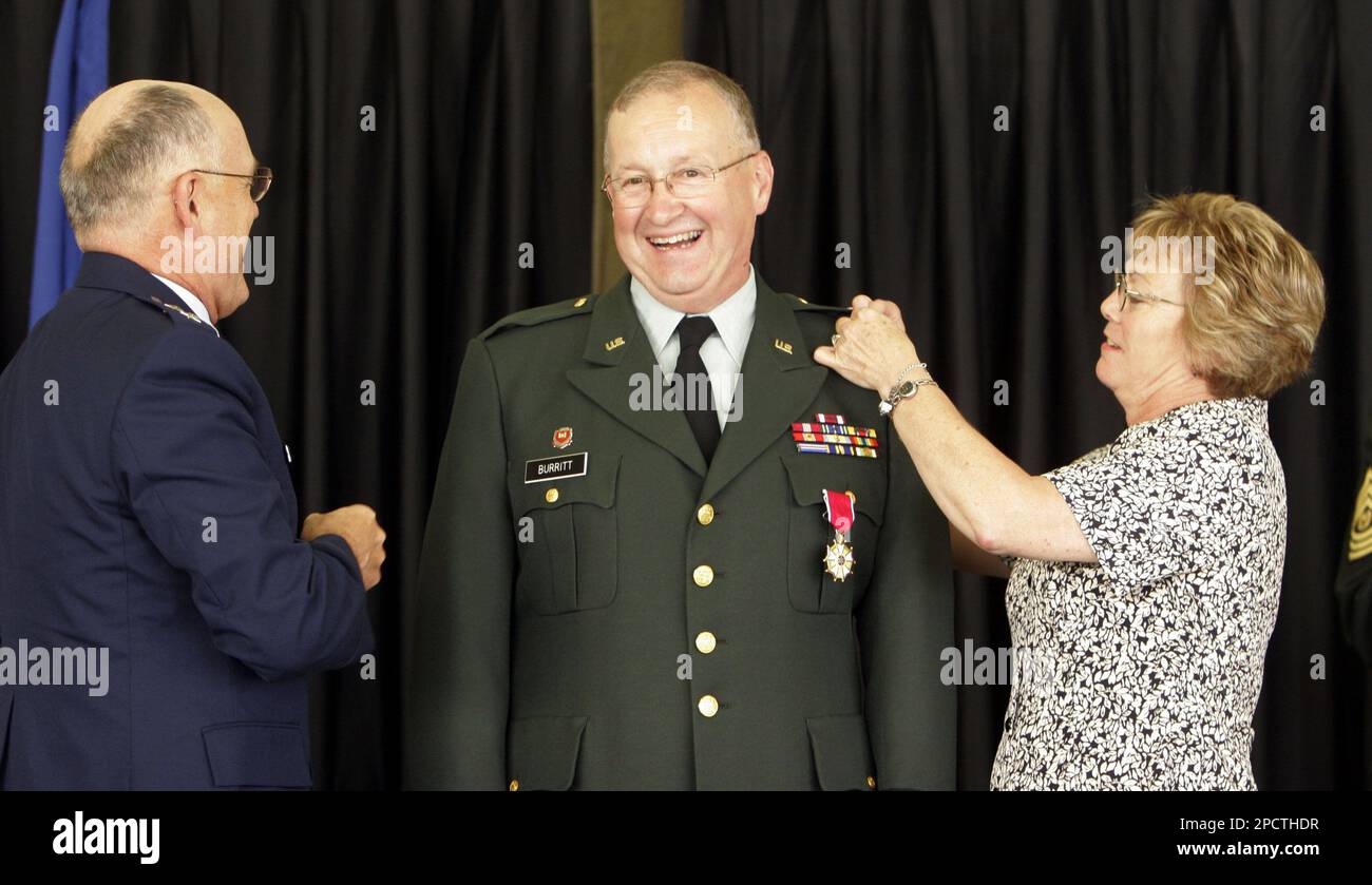 Brig. Gen. Stephen Burritt, center, smiles as he gets his stars pinned ...