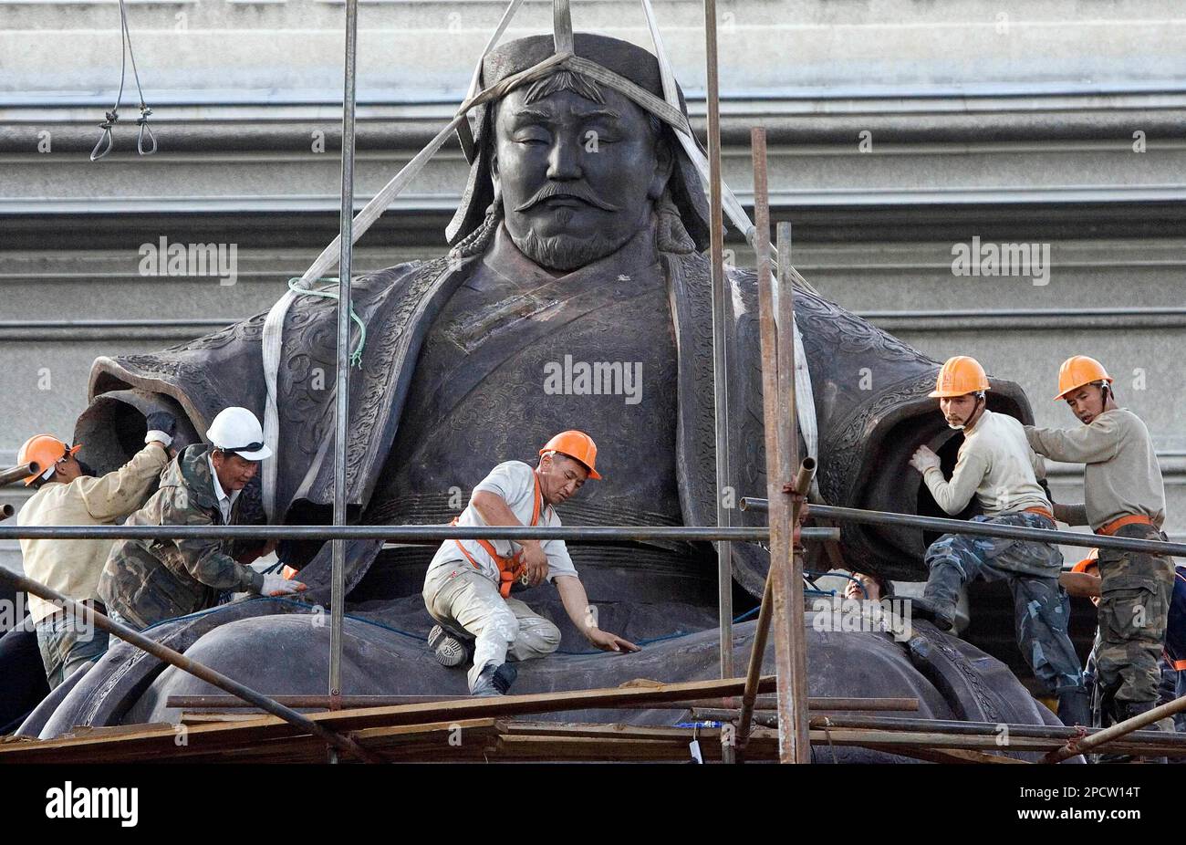 Workers installing a giant statue of Genghis Khan outside the Mongolian ...