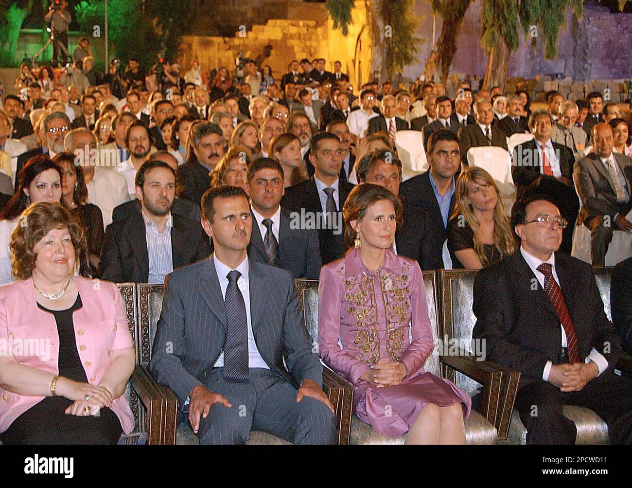 Syrian President Bashar Assad, second left, and his wife Asma, second ...