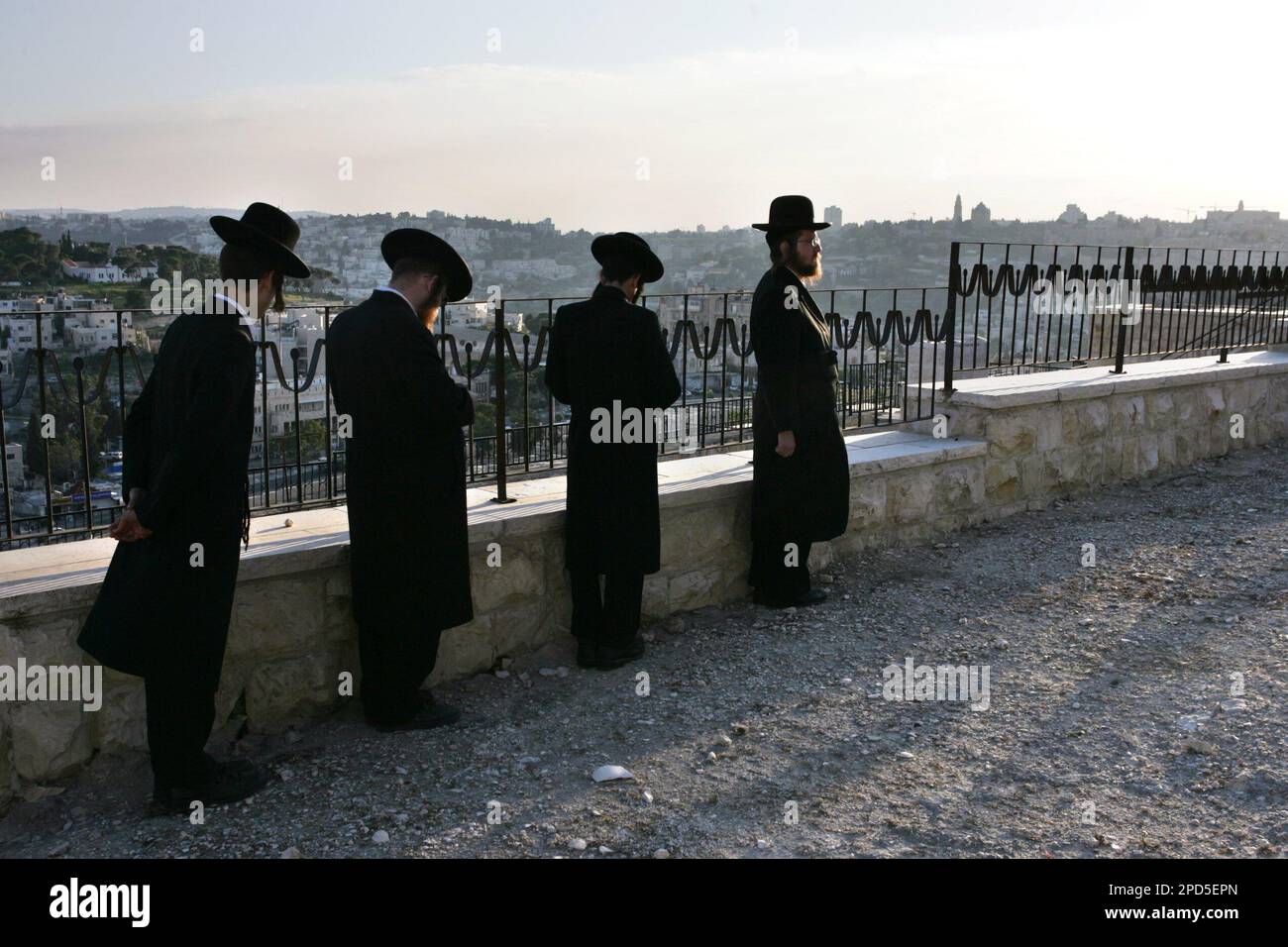 Ultra-Orthodox Jewish men pray as they wait for the body of Rabbi Moshe ...