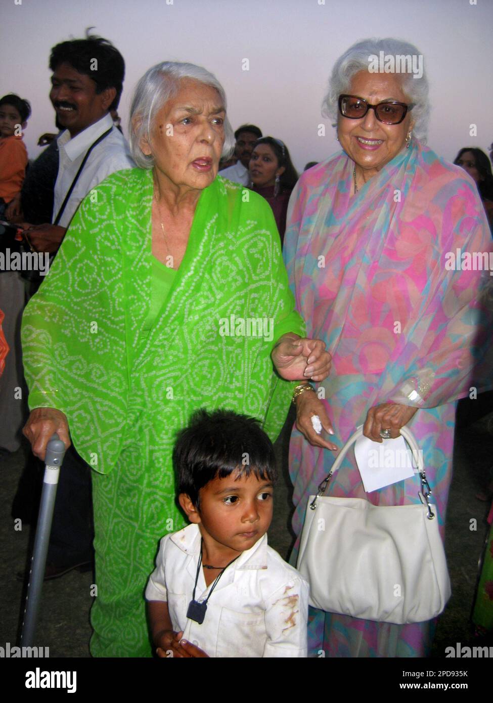 Maharani Gayatri Devi, left, enquires the welfare of a child, below ...