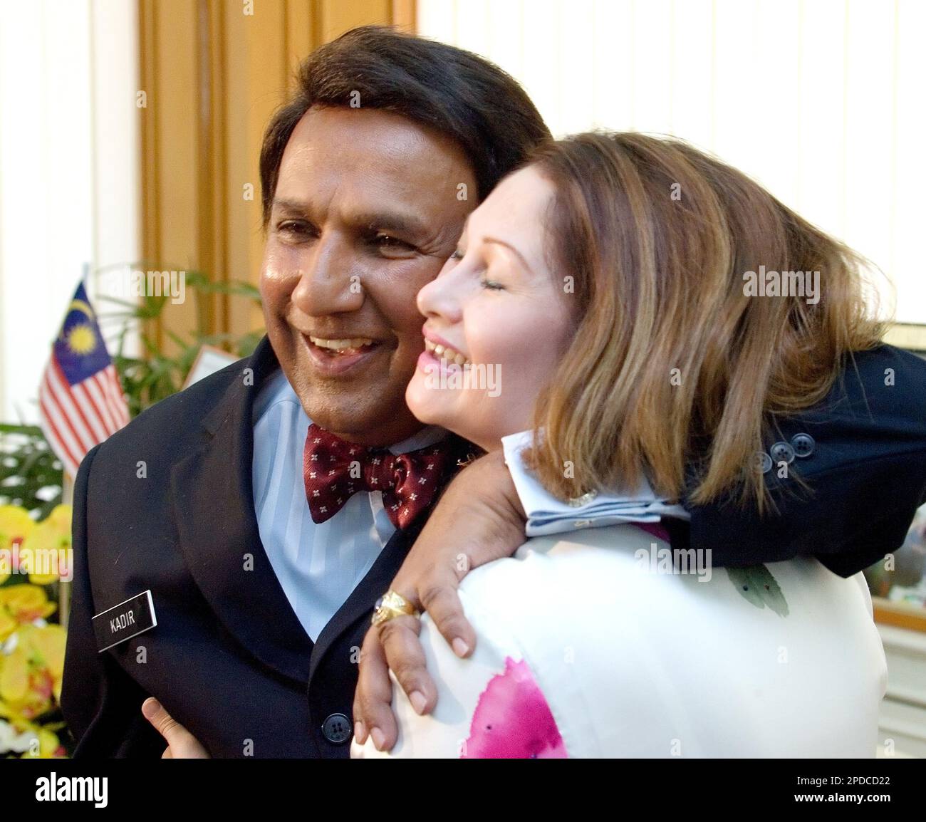 Malaysian Information Minister Kadir Sheikh Fadzir hugs his wife Suraya ...