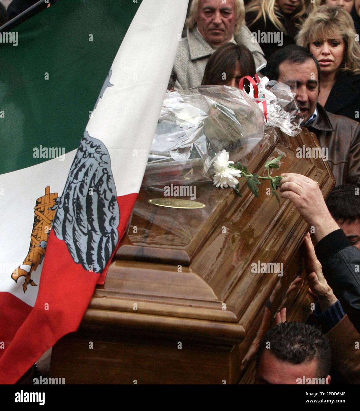 People waving an Italian flag bearing a fascist symbol greet the coffin ...