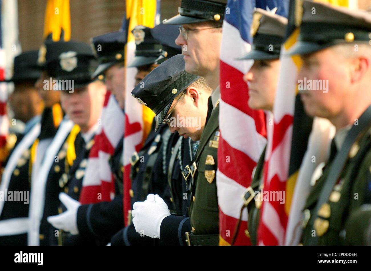 Gaithersburg City Police officer Dan B. Lane Jr., center, lowers his ...