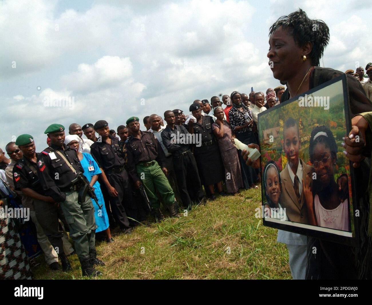 Ify Ilabor, holds up the picture of her three children who died in the ...