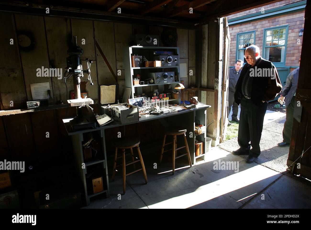 George Bodway, right center, takes a sneak peek at the historic garage ...