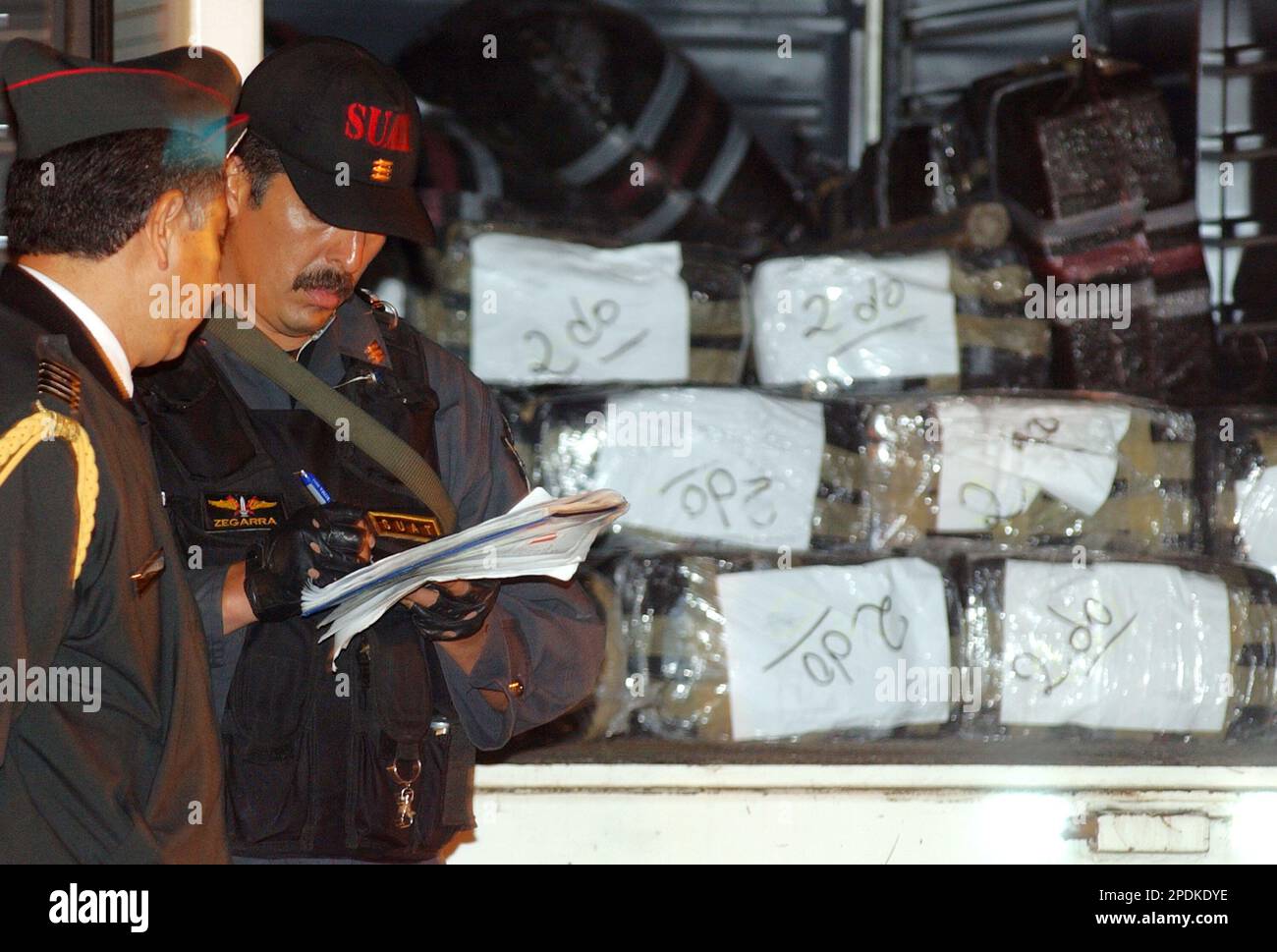 Two officials count packages of cocaine at the police airport base in ...