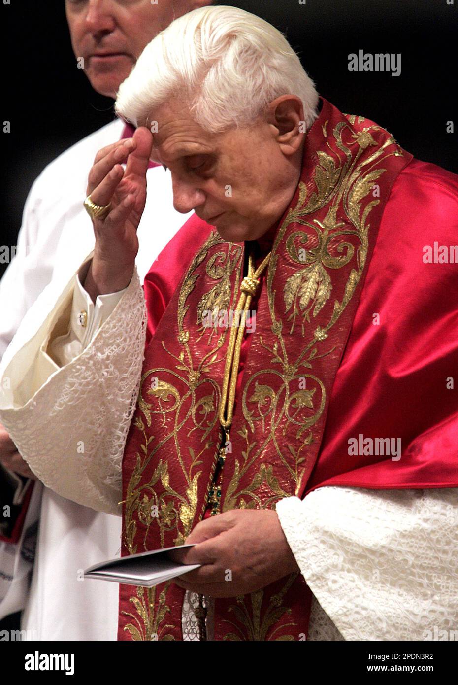 Pope Benedict XVI makes the sign of the cross during a solemn adoration ...