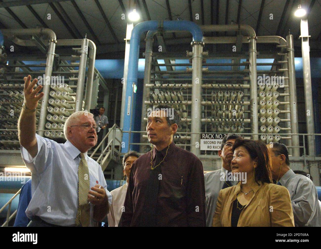 Officials from Hyflux, a Singapore-based water treatment company, guide ...