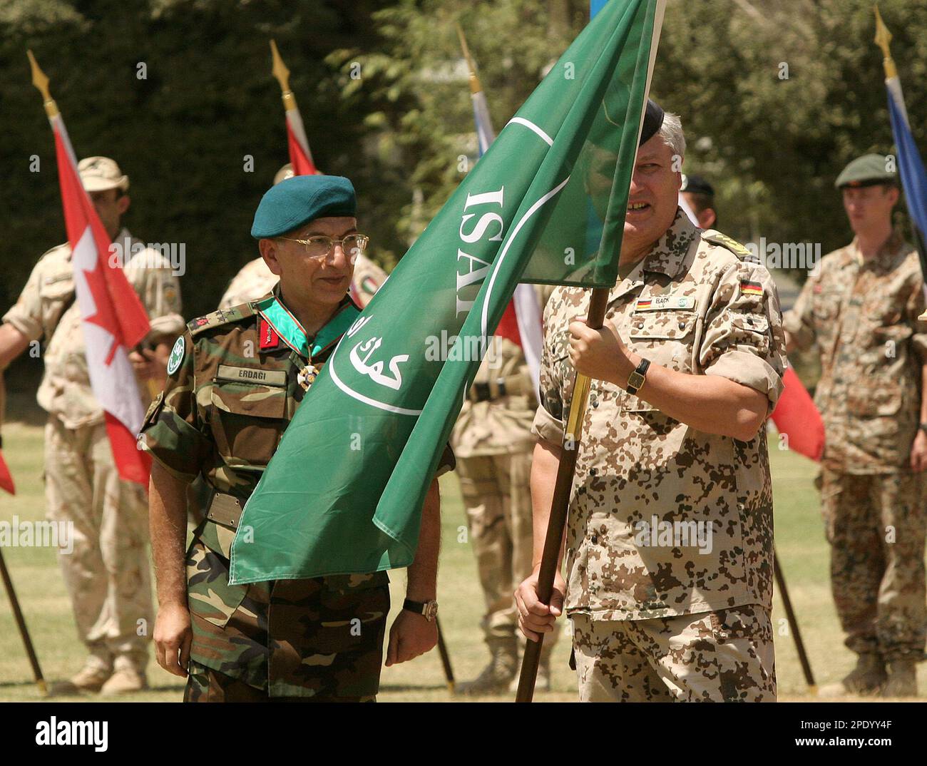 Turkish Lt. Gen. Ethem Erdagi, former Commander ISAF, left, gives the ...