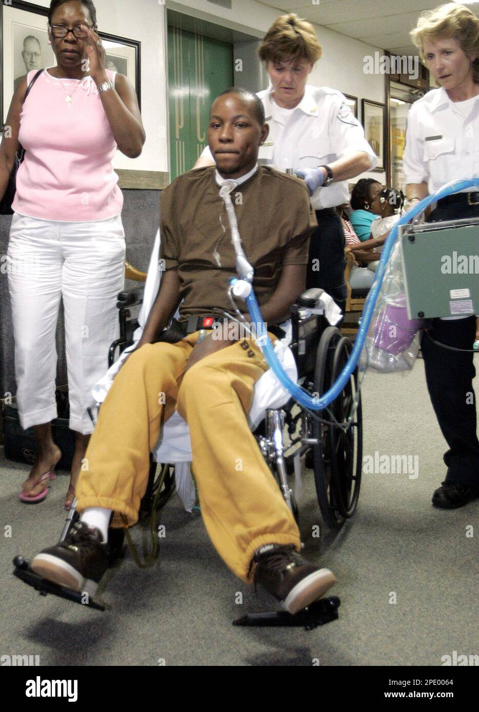Dennis Scales, in wheelchair, who was left a quadriplegic following a ...