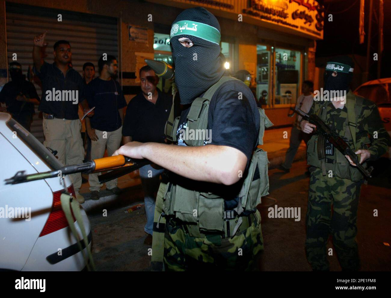 Palestinian masked Hamas militants are seen in the street following ...