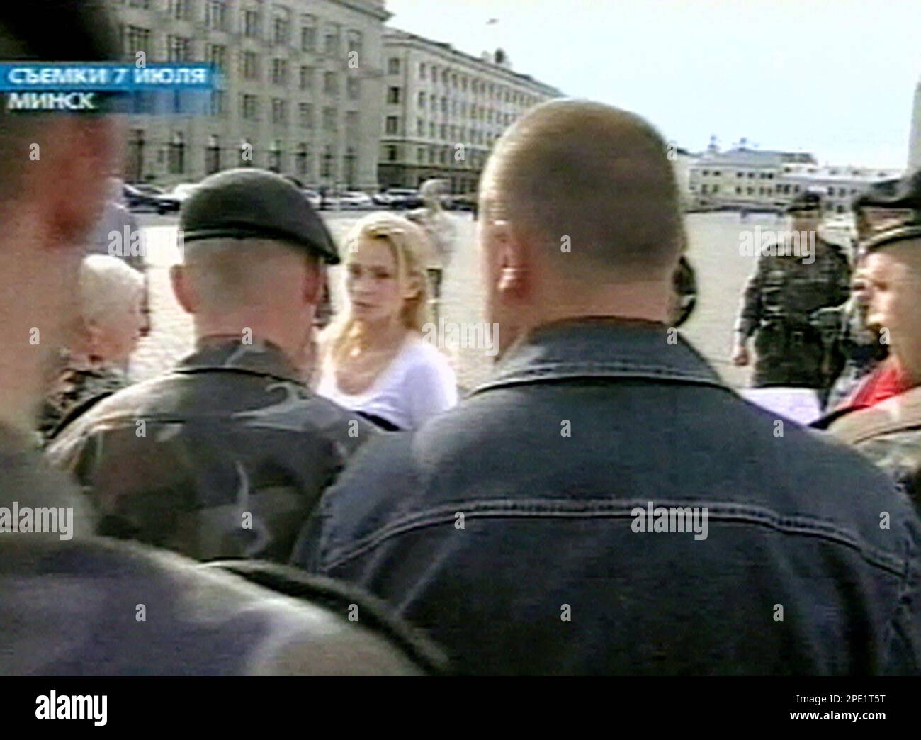 A Belarusian riot police officer argues with wife of disappeared ...