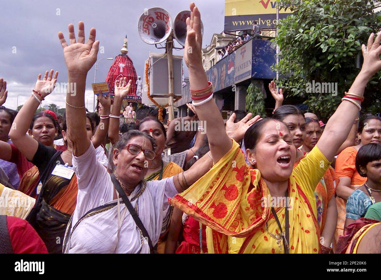 Devotees chants prayers and dance in front of a chariot of Hindu God ...