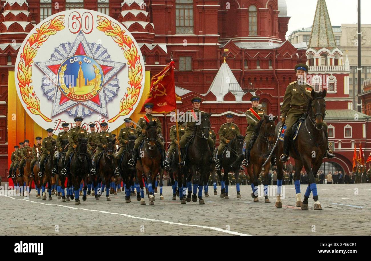 Russian mounted soldiers dressed in Soviet WWII uniforms ride along Red ...