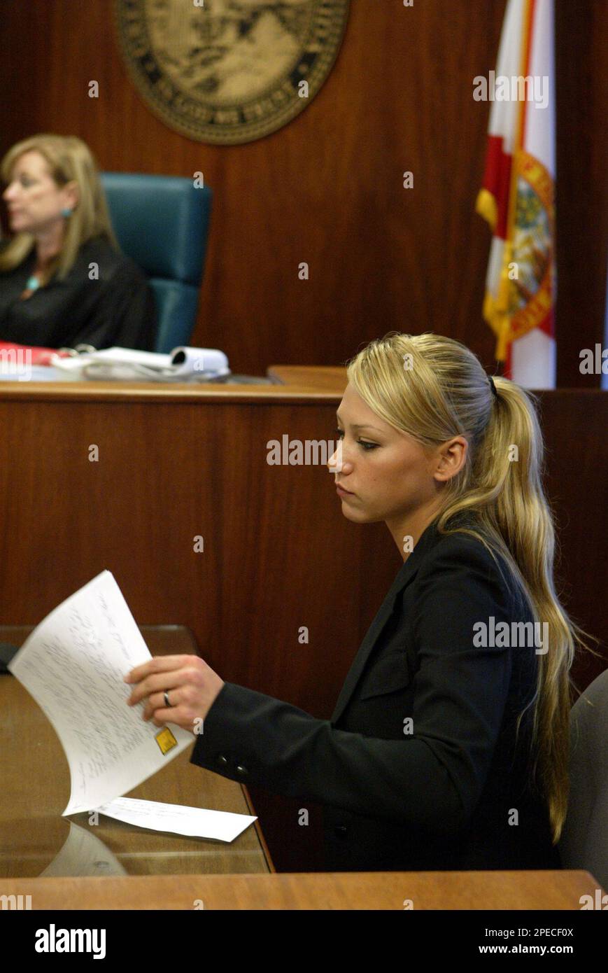 Tennis star Anna Kournikova reads portions of a letter from accused ...