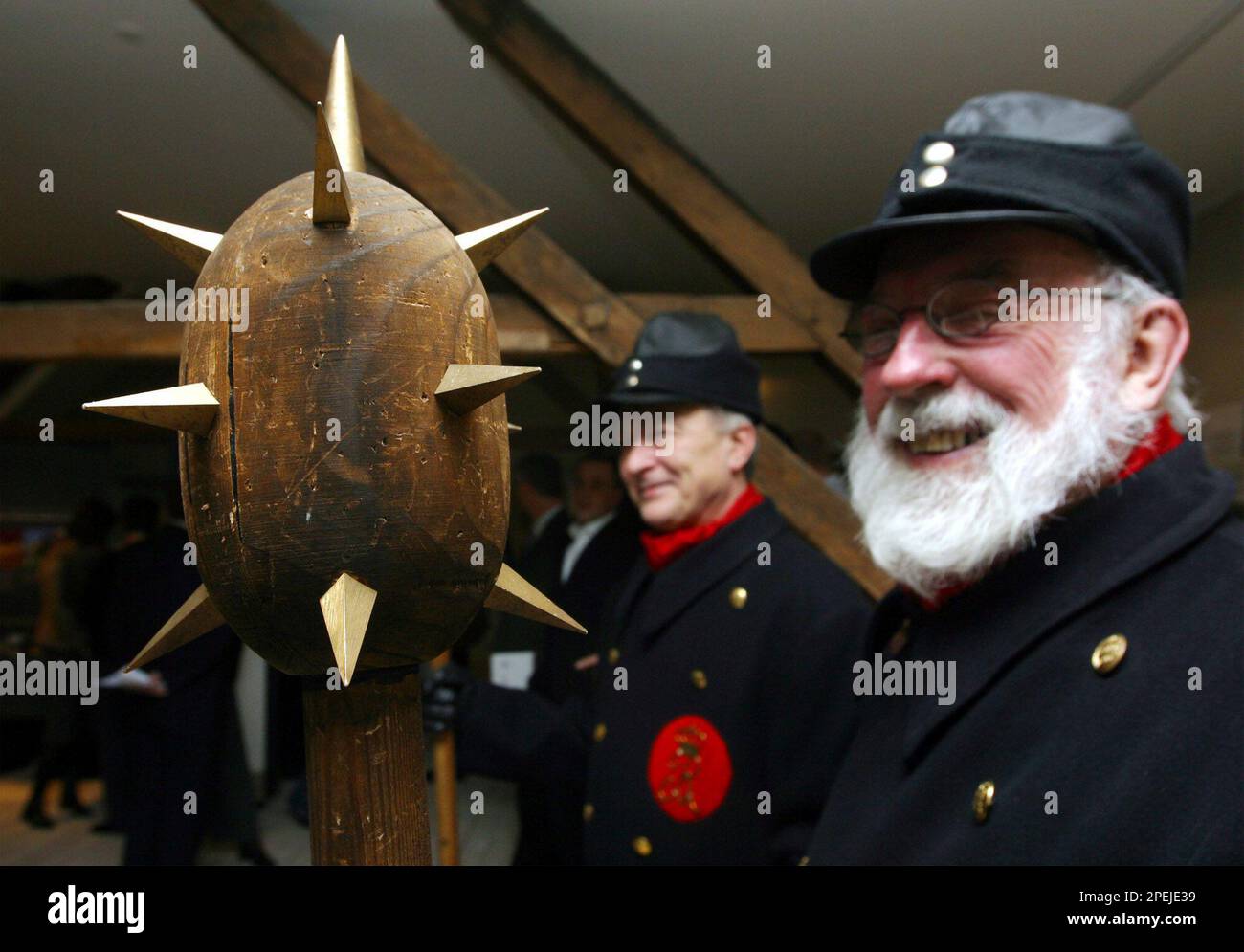 Men dressed as night watchmen armed with spiked clubs from the time of ...