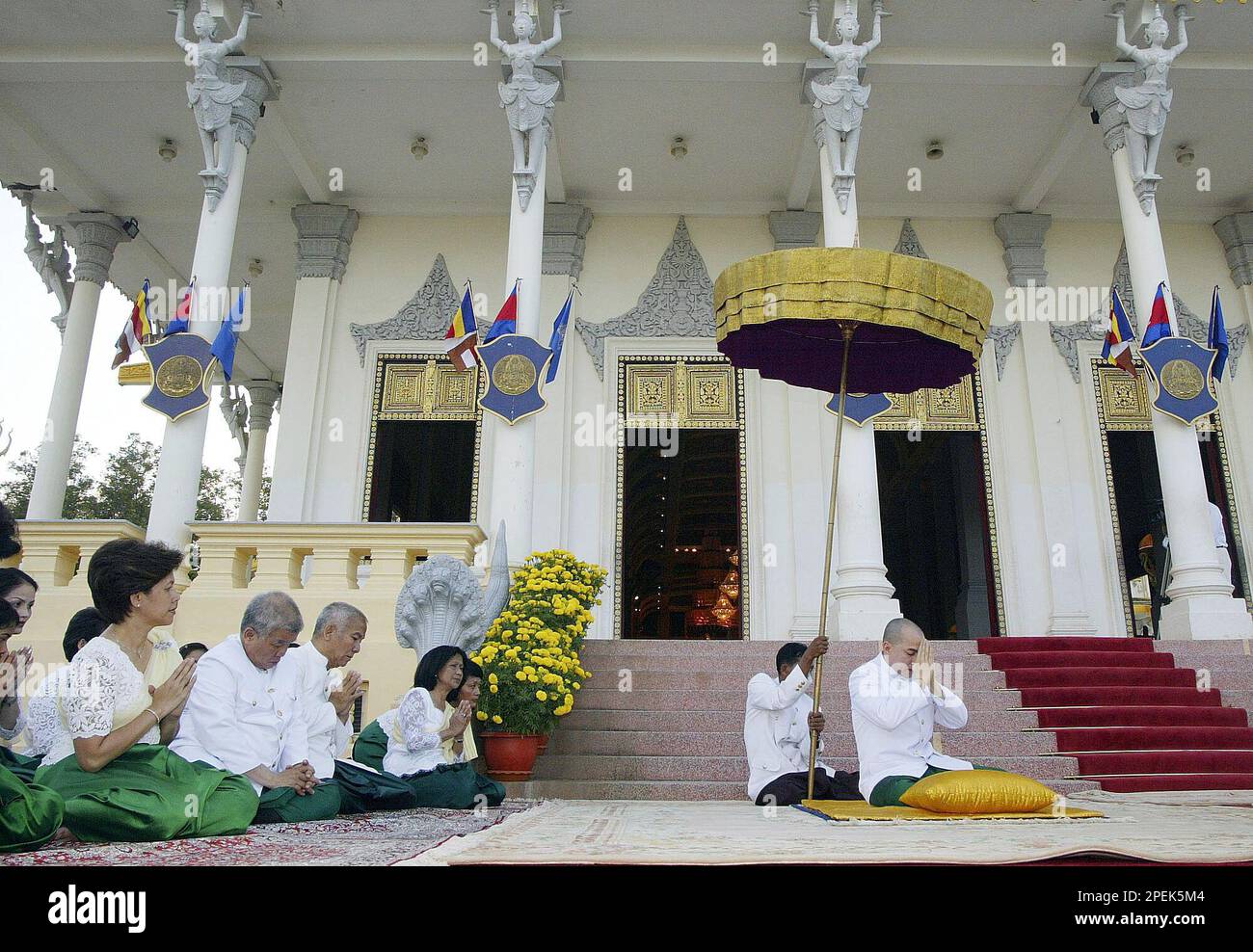 Cambodia's King Norodom Sihamoni (R) prays with royal family members (L ...