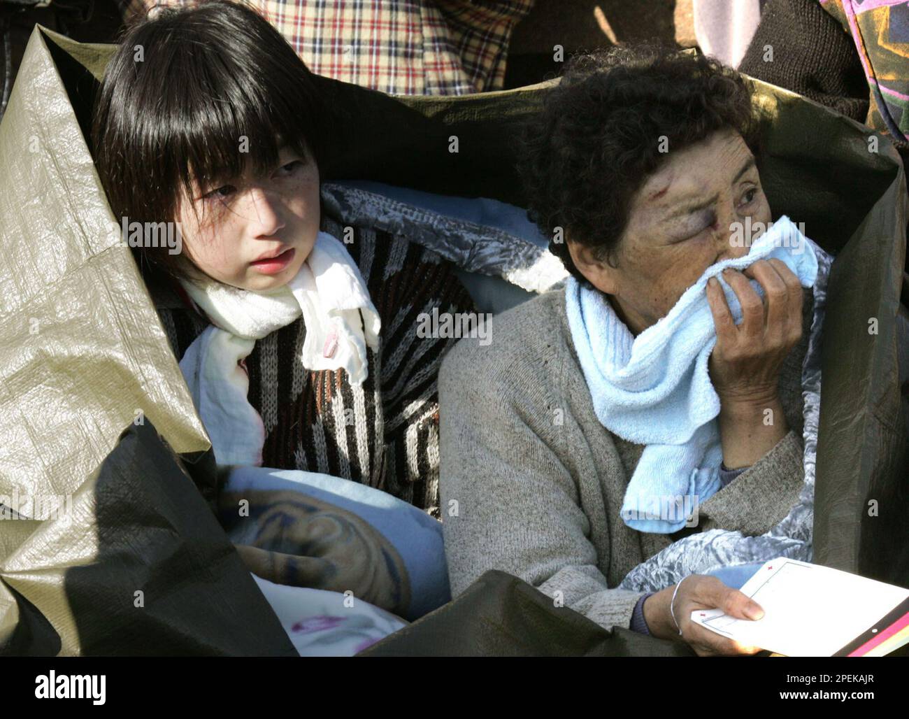Earthquake victims take a rest at an evacuation center in Ojiya ...