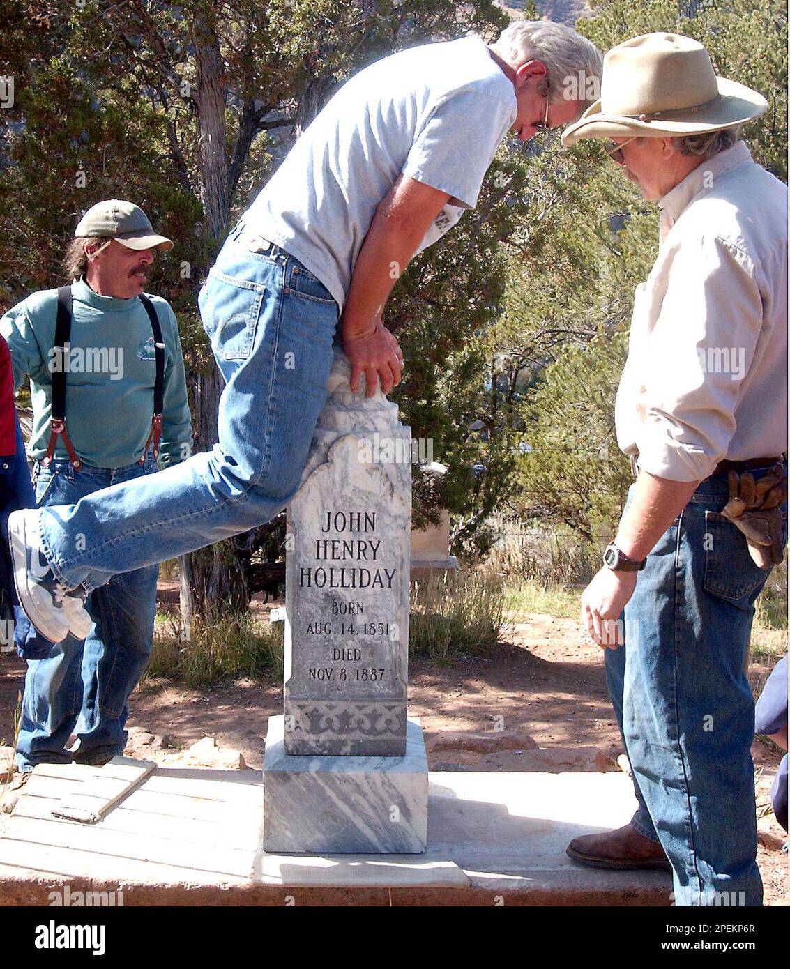 Jim Matticks, owner of Snyder Grand Valley Memorials, Inc., puts his weight to help set Doc ...