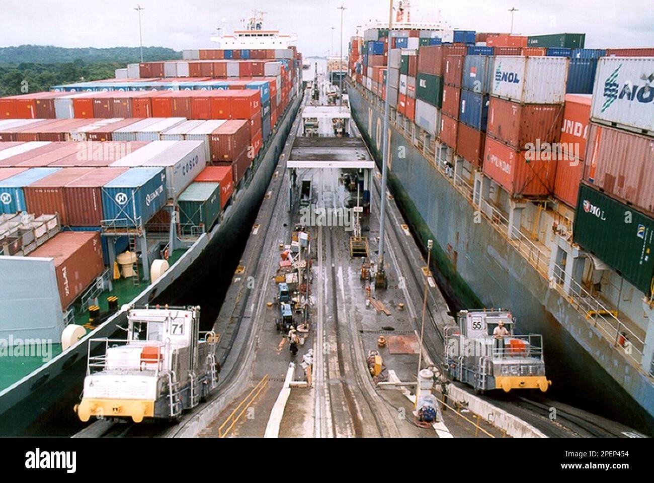Panamax cargo vessels pass over the Gatun Locks of the Panama Canal ...