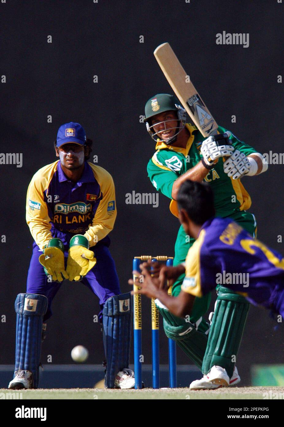 Sri Lanka's bowler Upul Chandana dives to stop the ball as South Africa ...