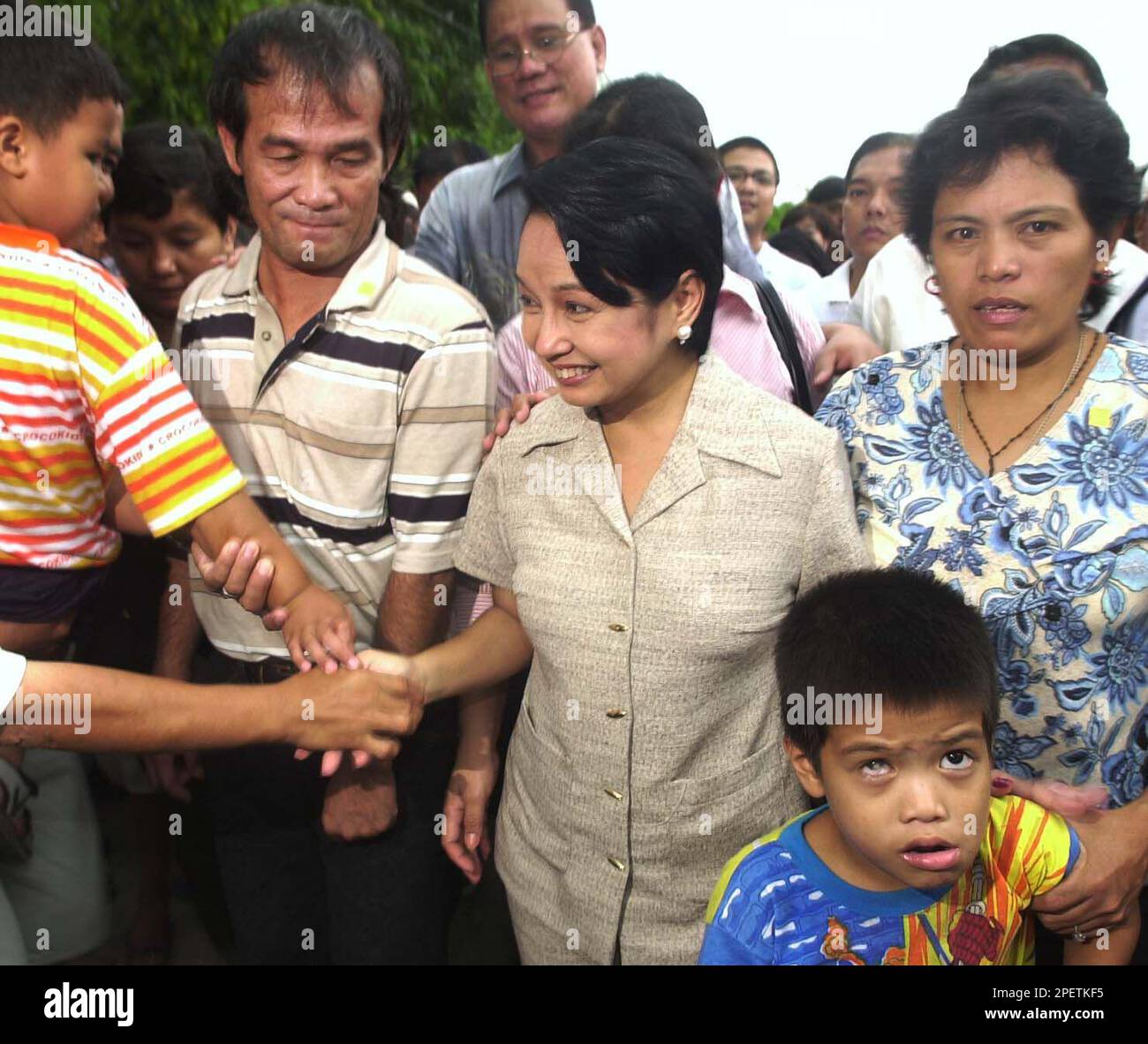 Philippine President Gloria Macapagal Arroyo, center, greets the crowd ...